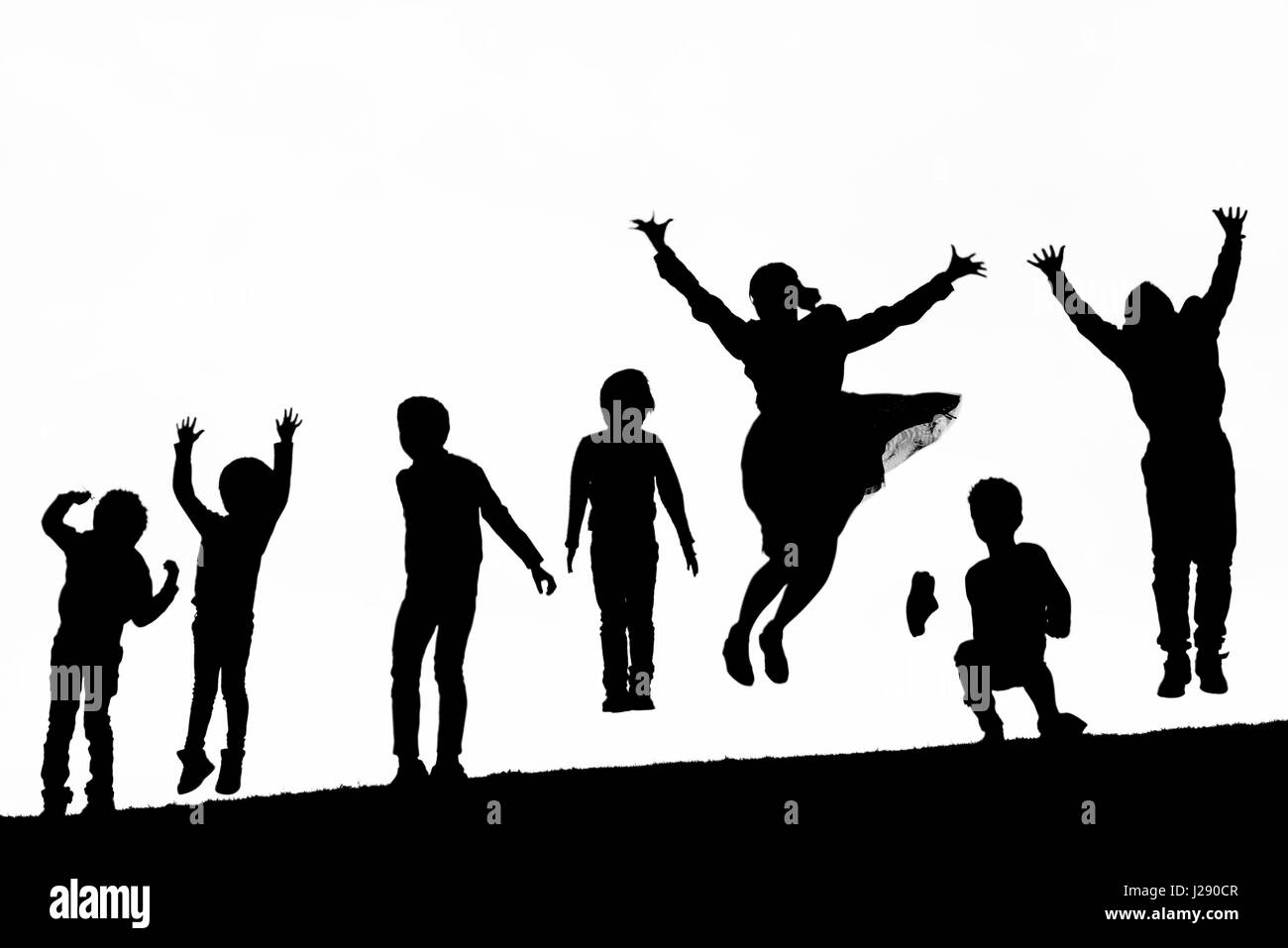 Shadow people playing and jumping on top of the hill Stock Photo - Alamy