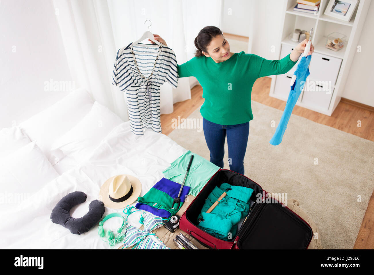 woman packing travel bag at home or hotel room Stock Photo - Alamy