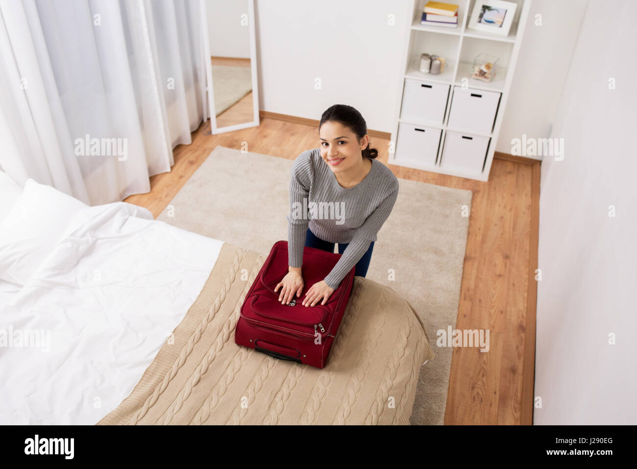 woman packing travel bag at home or hotel room Stock Photo - Alamy