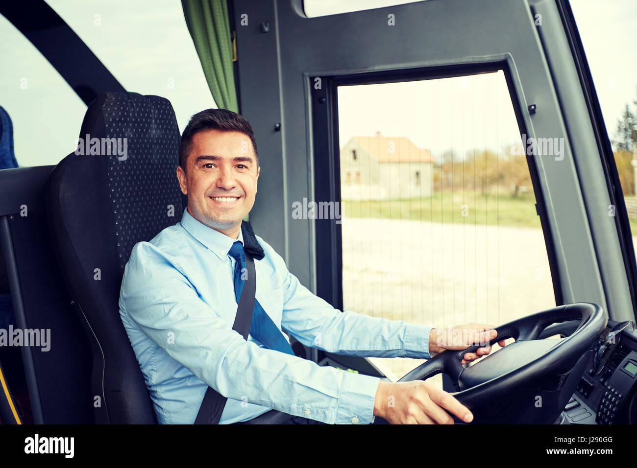 happy driver driving intercity bus Stock Photo - Alamy