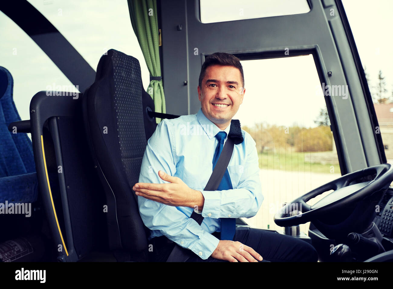 happy driver inviting on board of intercity bus Stock Photo - Alamy