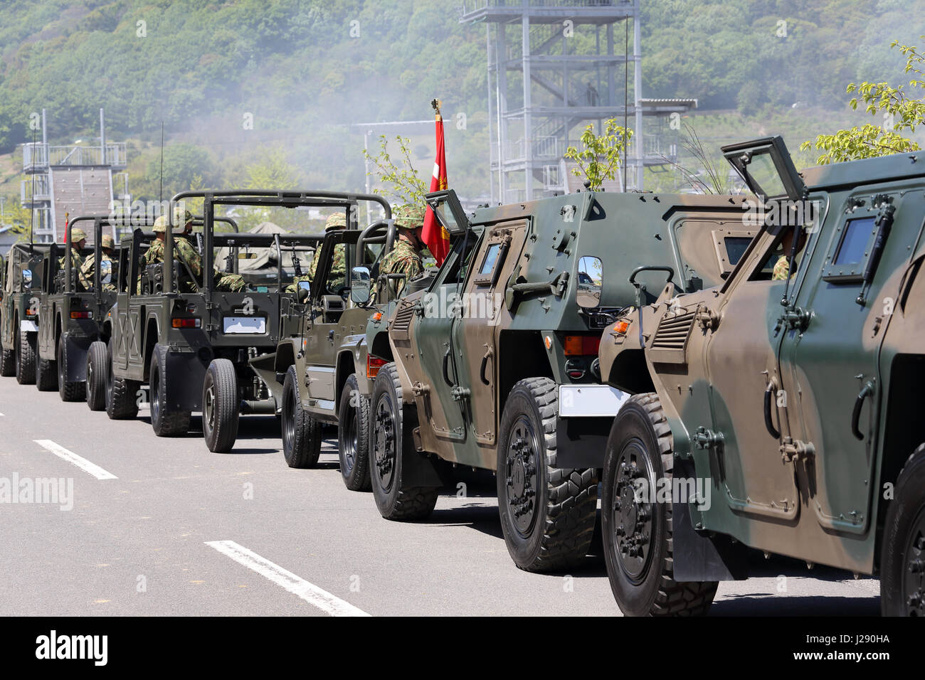 Japanese armored vehicle departs with Japanese soldier Stock Photo - Alamy