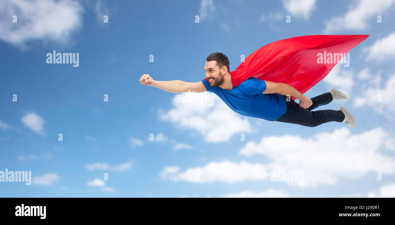 happy man in red superhero cape flying on air Stock Photo - Alamy