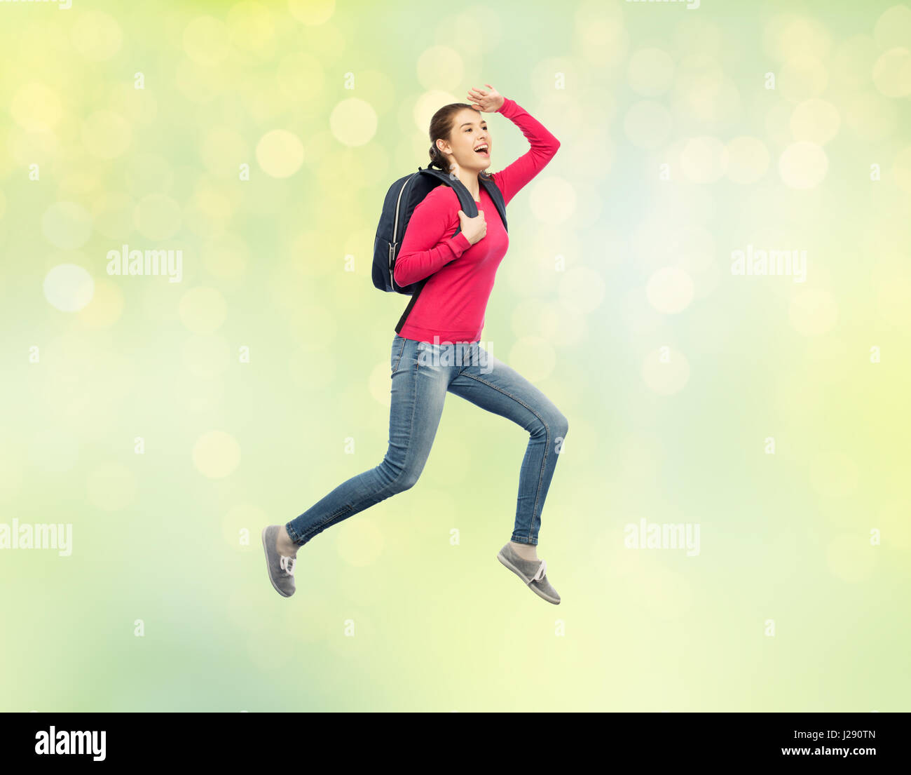 happy woman or student with backpack jumping Stock Photo - Alamy