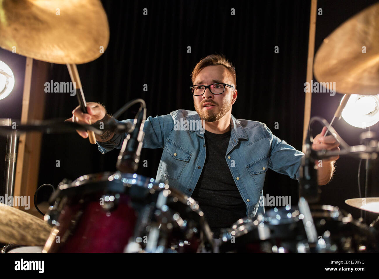 male musician playing drums and cymbals at concert Stock Photo - Alamy