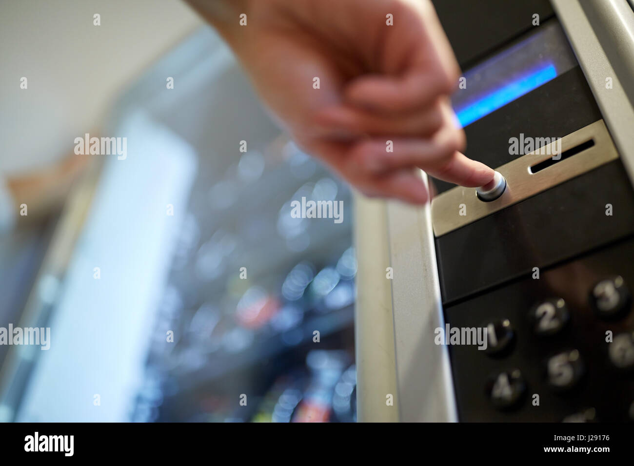 hand pushing button on vending machine Stock Photo - Alamy