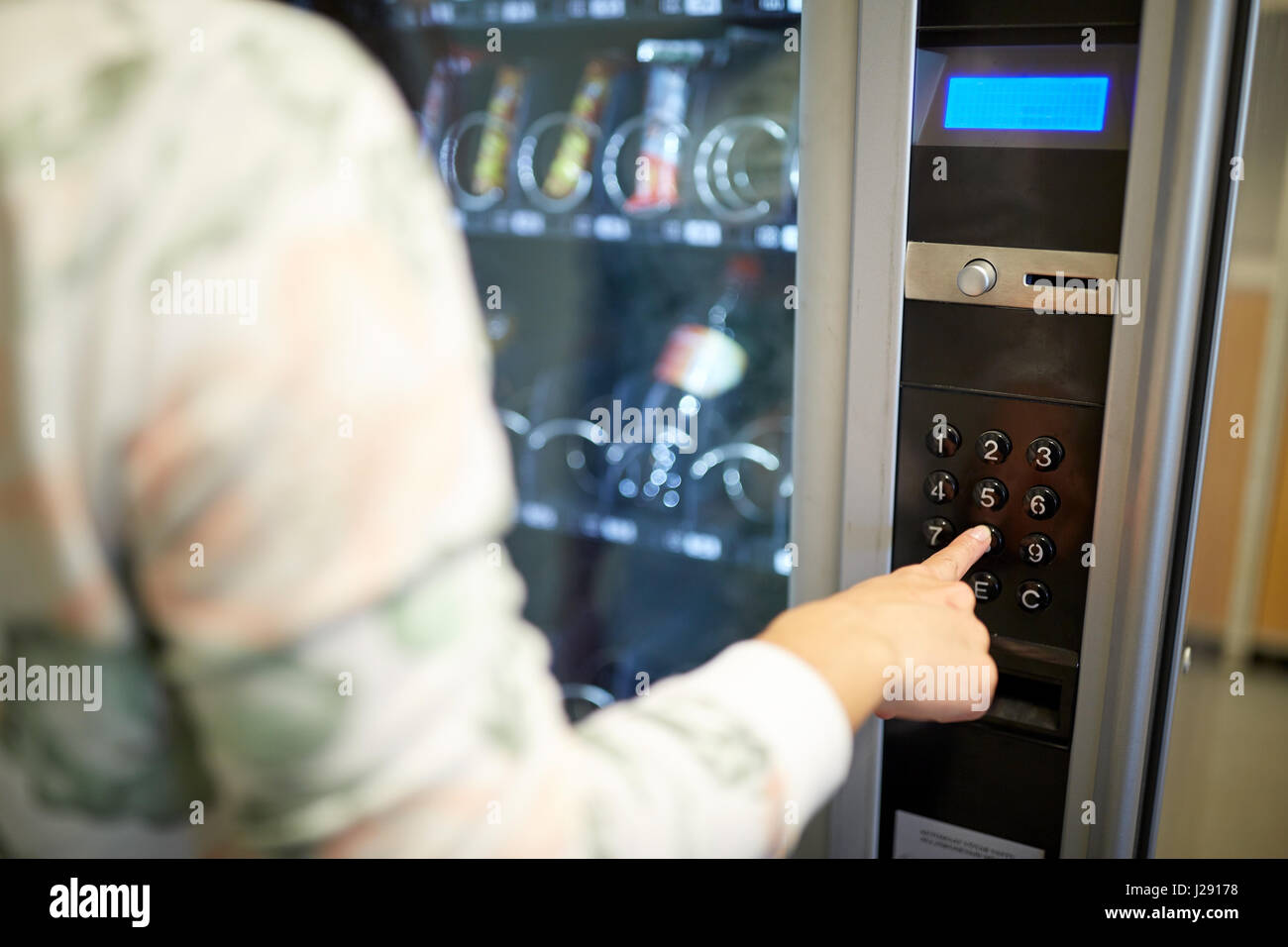 hand pushing button on vending machine keyboard Stock Photo - Alamy