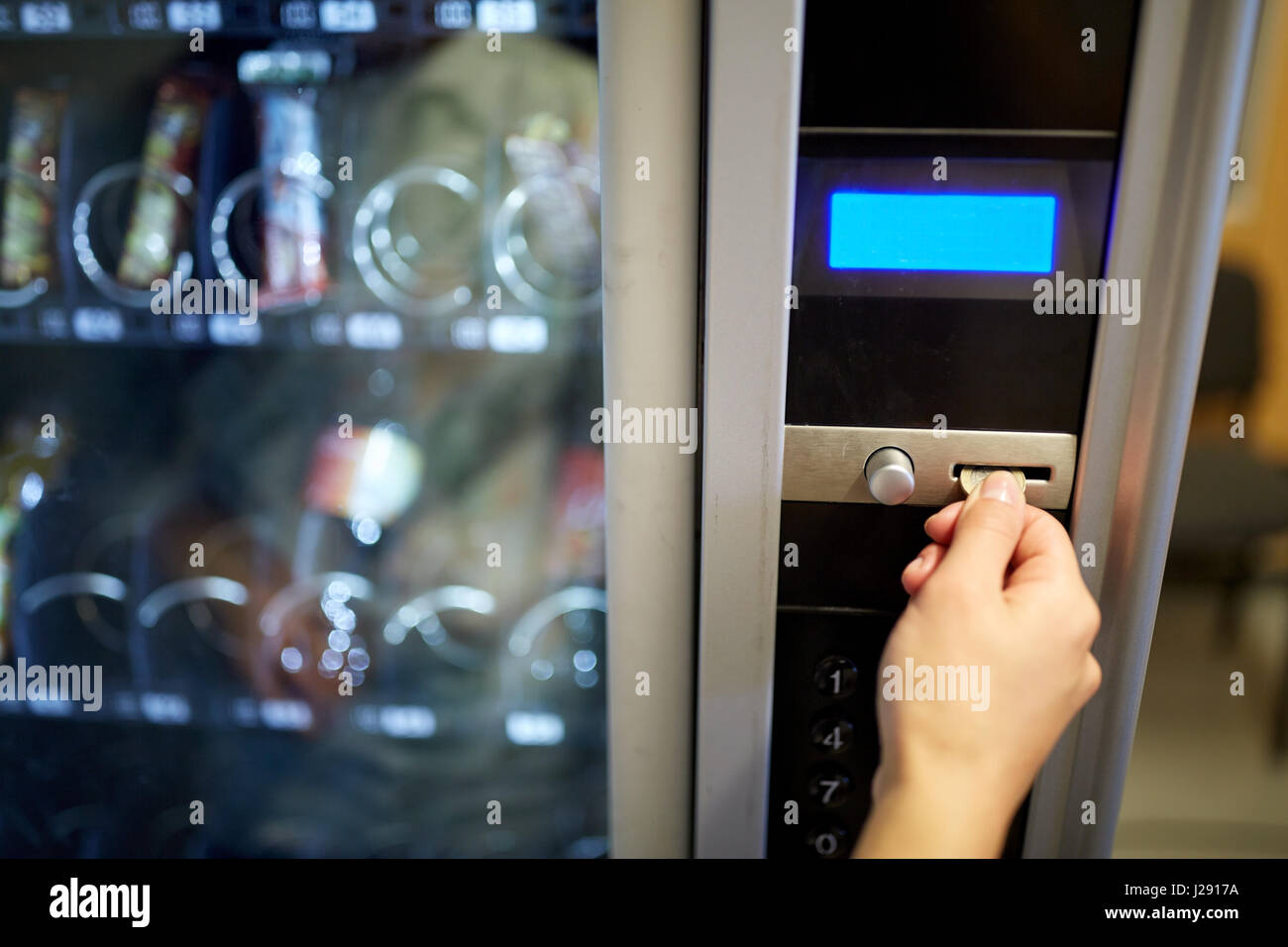 Woman buying snacks vending machine hi-res stock photography and images ...