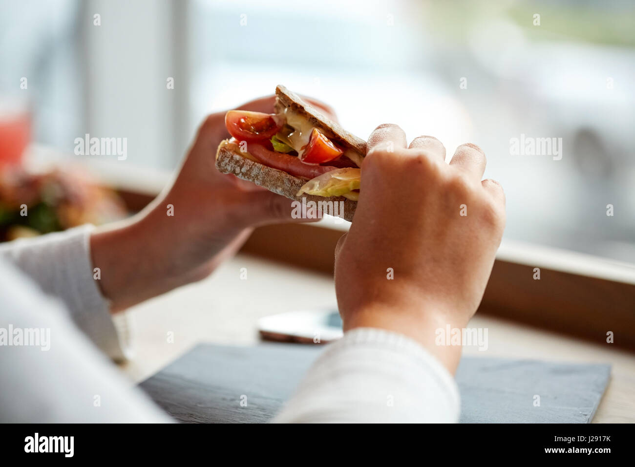 Person eating sandwich hi-res stock photography and images - Alamy