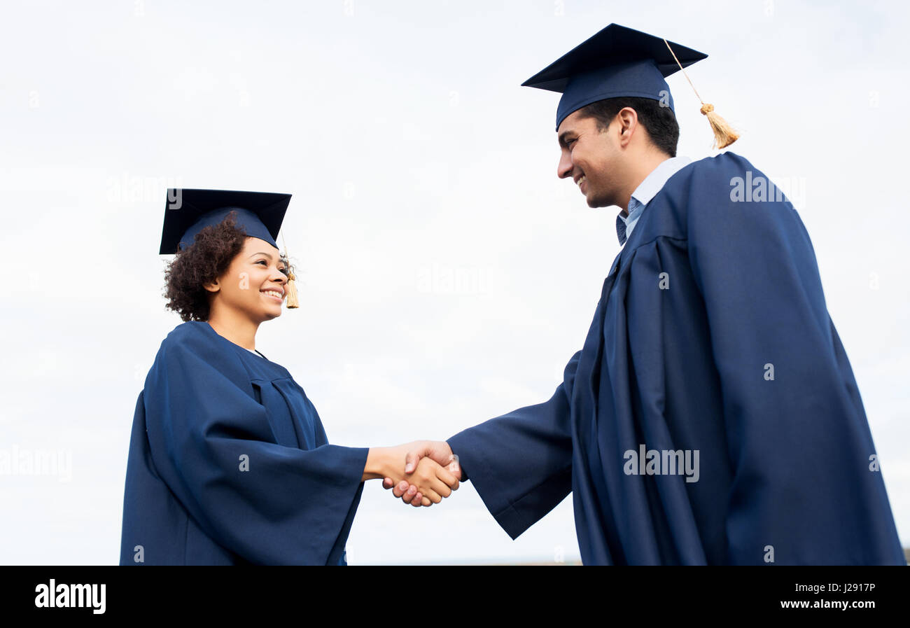 happy students or bachelors greeting each other Stock Photo - Alamy