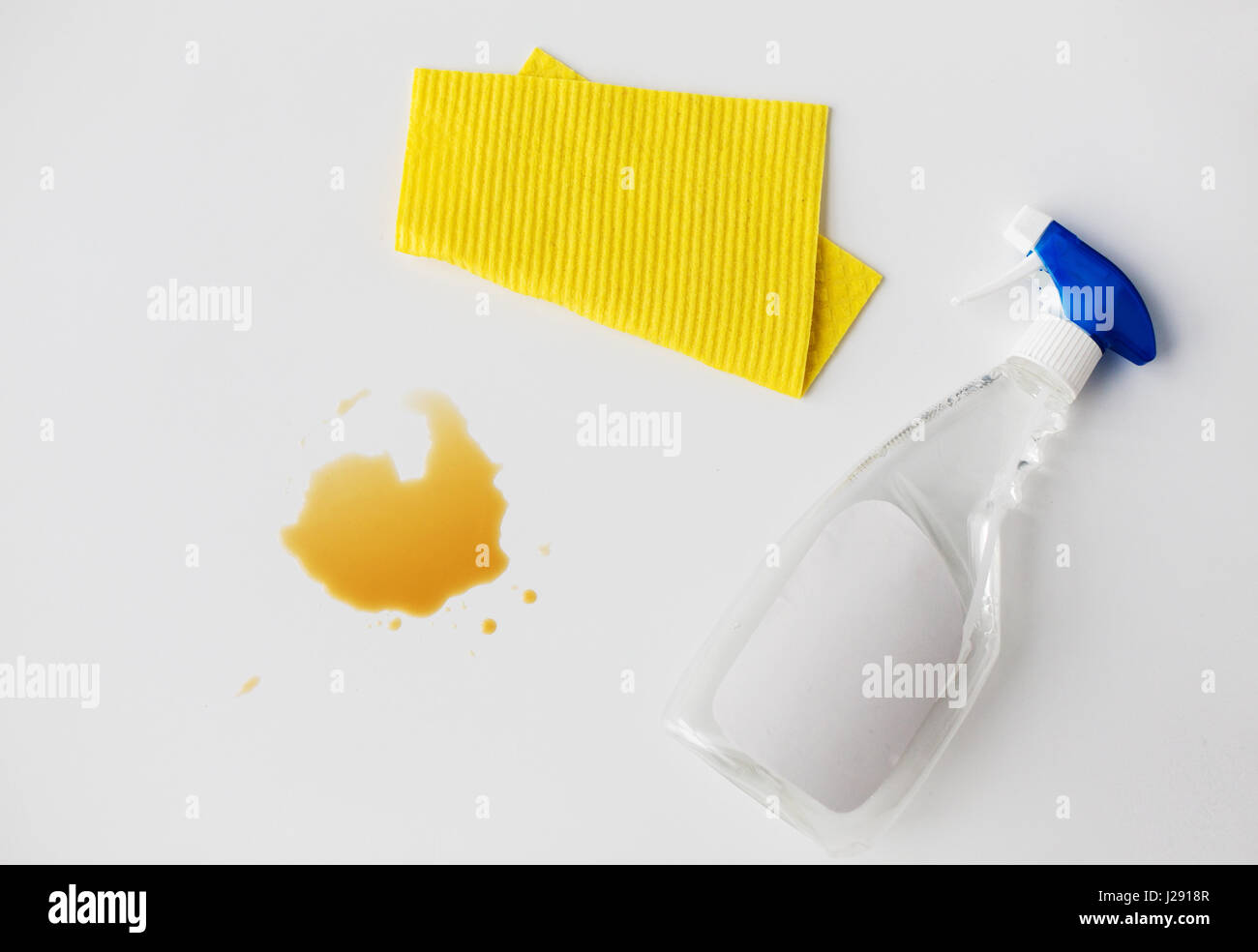 cleaning rag, detergent spray and spilled stain Stock Photo - Alamy
