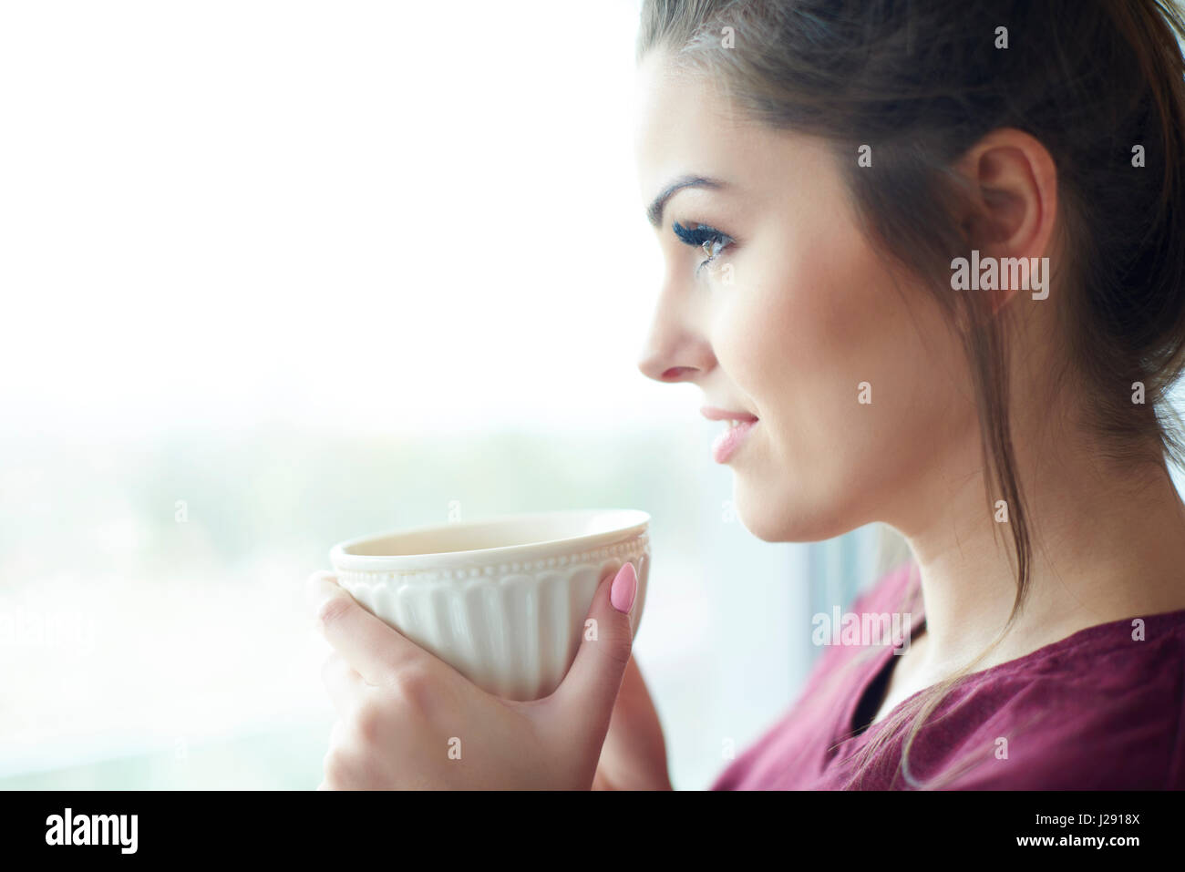 Headshot of attractive woman having morning coffee Stock Photo - Alamy