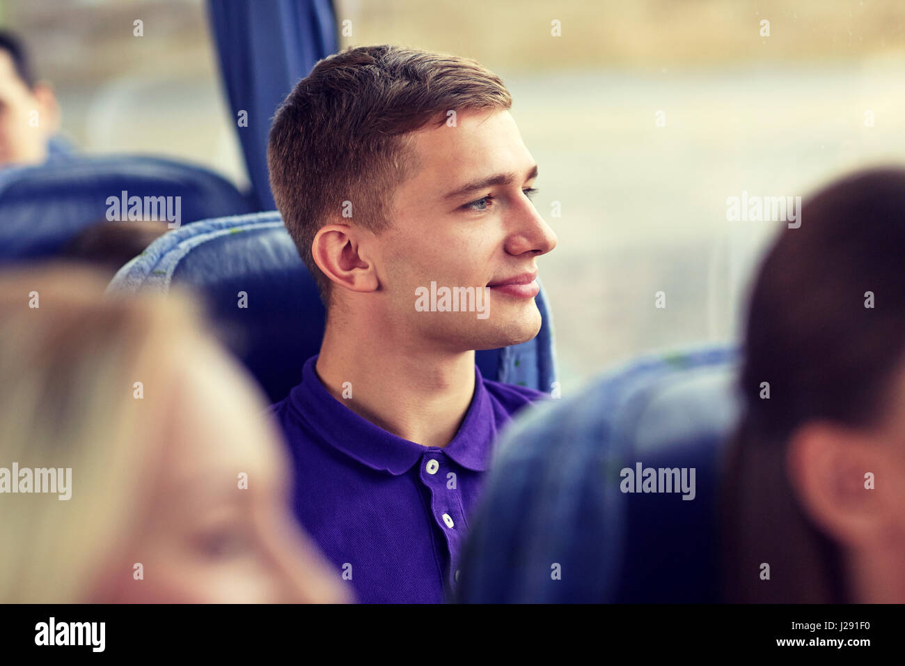 happy young man sitting in travel bus Stock Photo - Alamy