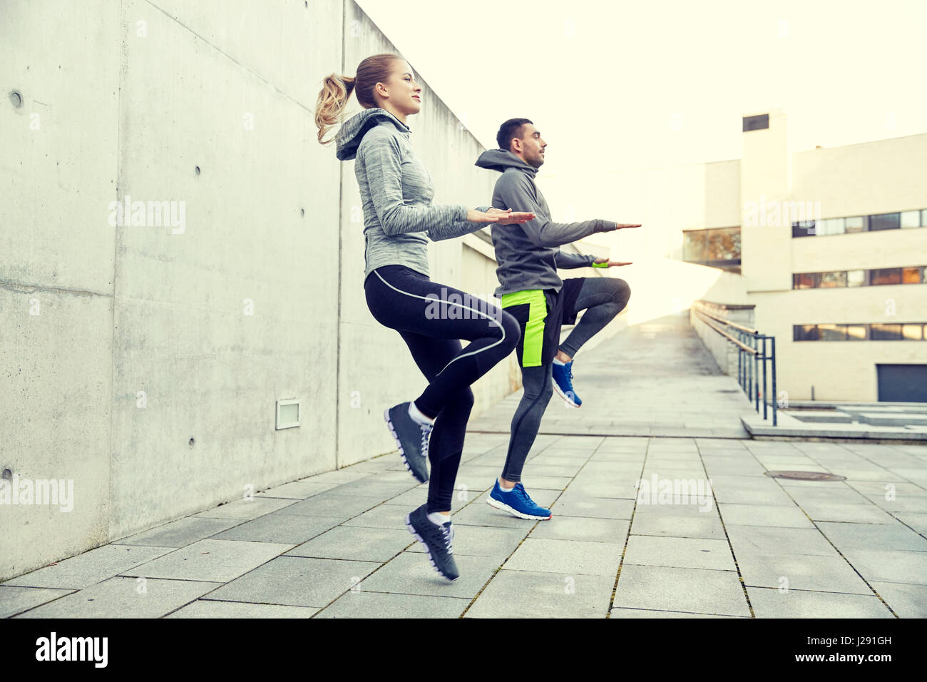 happy man and woman jumping outdoors Stock Photo - Alamy
