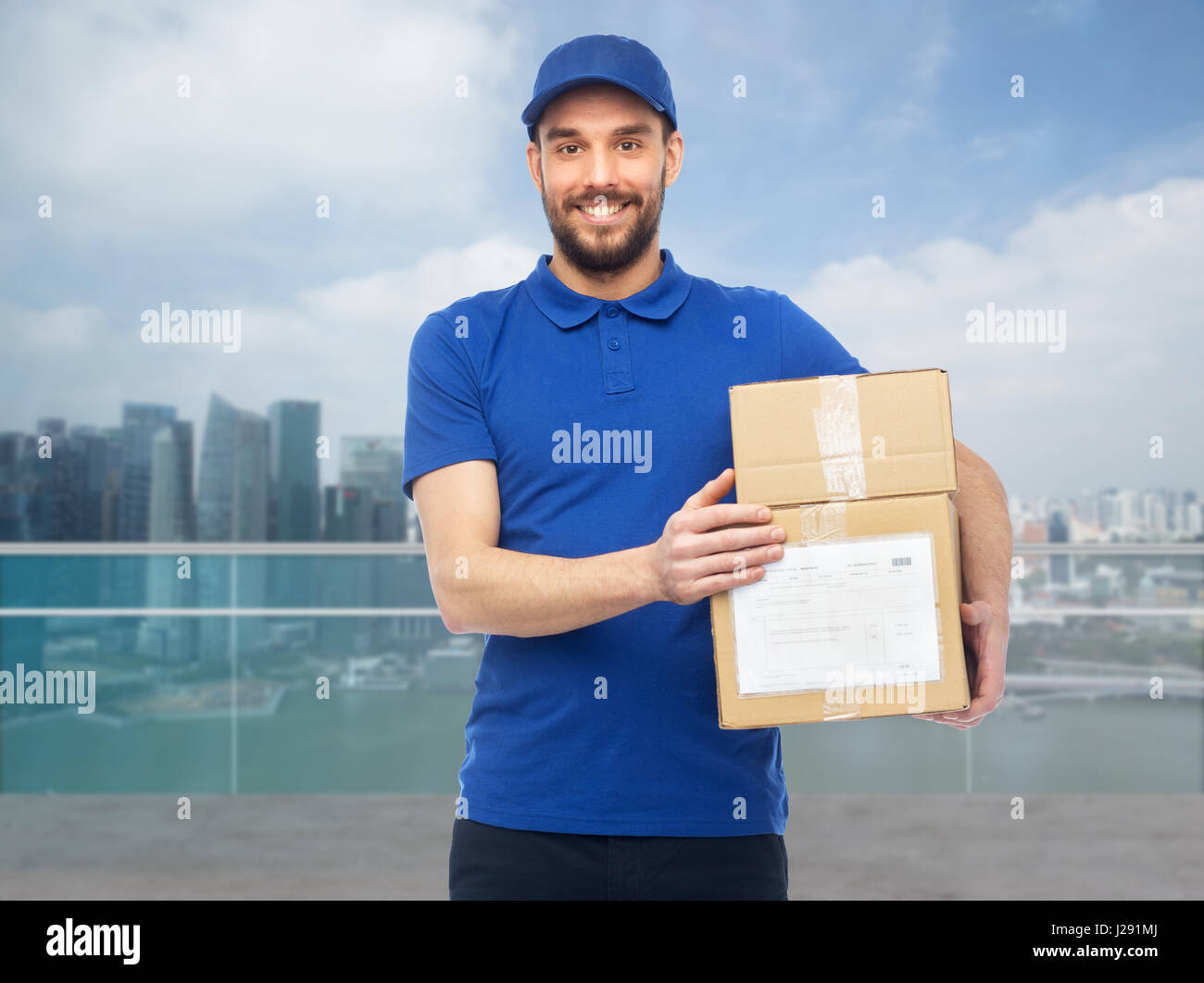 happy delivery man with boxes over singapore city Stock Photo - Alamy