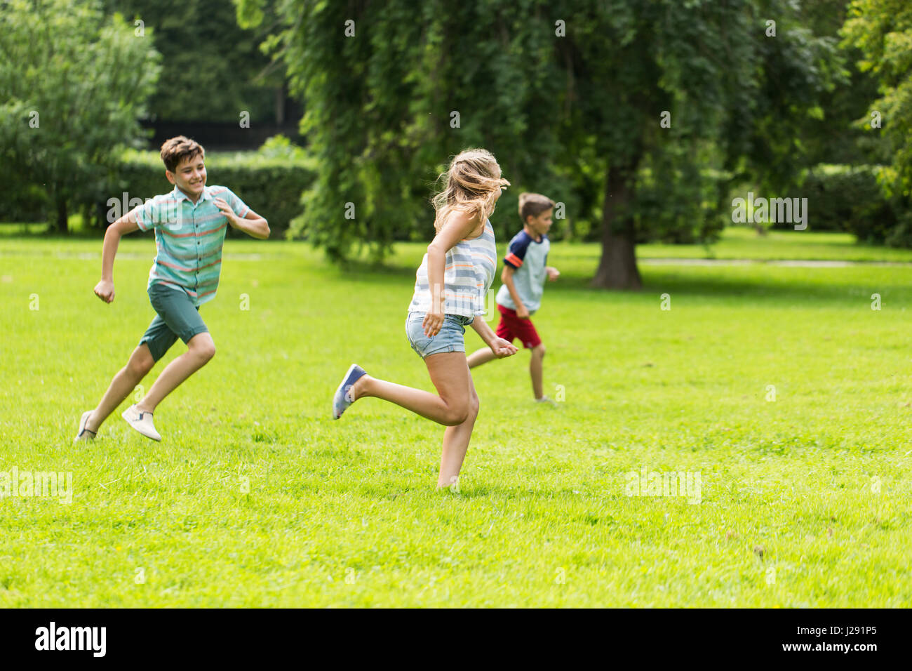 group of happy kids or friends playing outdoors Stock Photo - Alamy