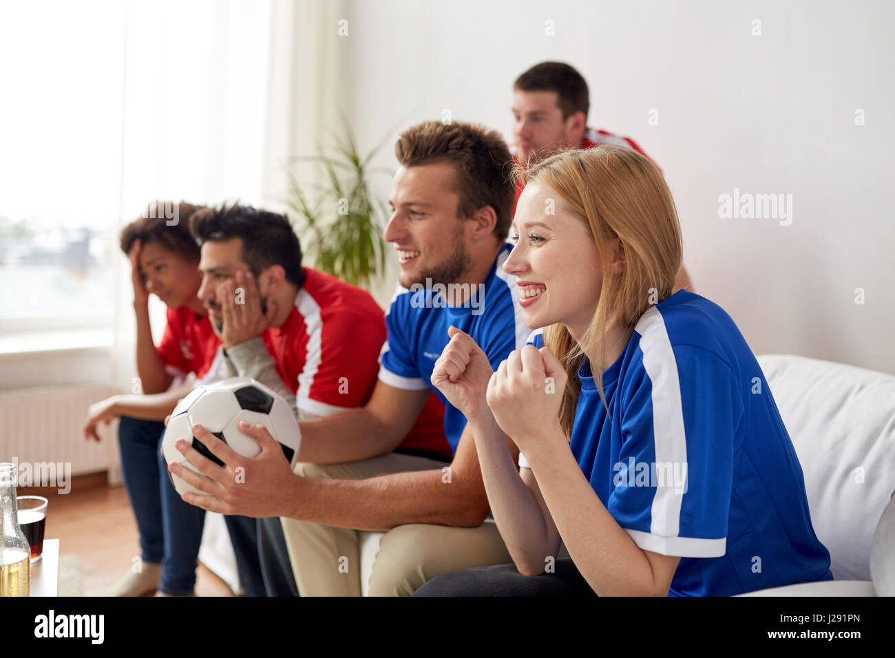 Girl watching football sofa hi-res stock photography and images - Alamy
