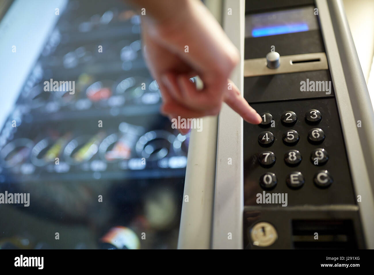 hand pushing button on vending machine keyboard Stock Photo - Alamy