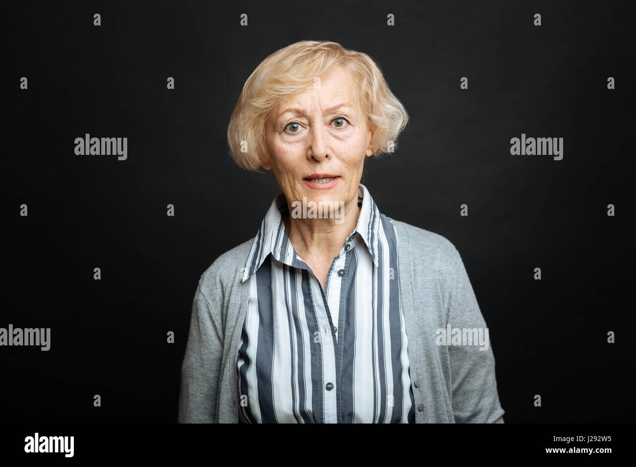 Angry old woman expressing discontent in the black colored studio Stock ...