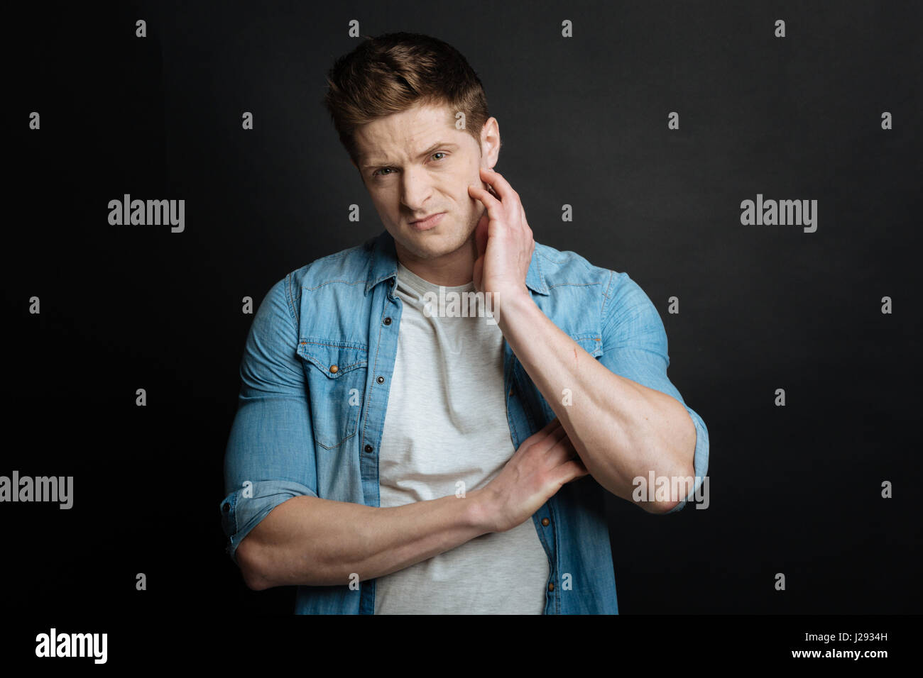 Displeased man expressing discontent in the studio Stock Photo - Alamy