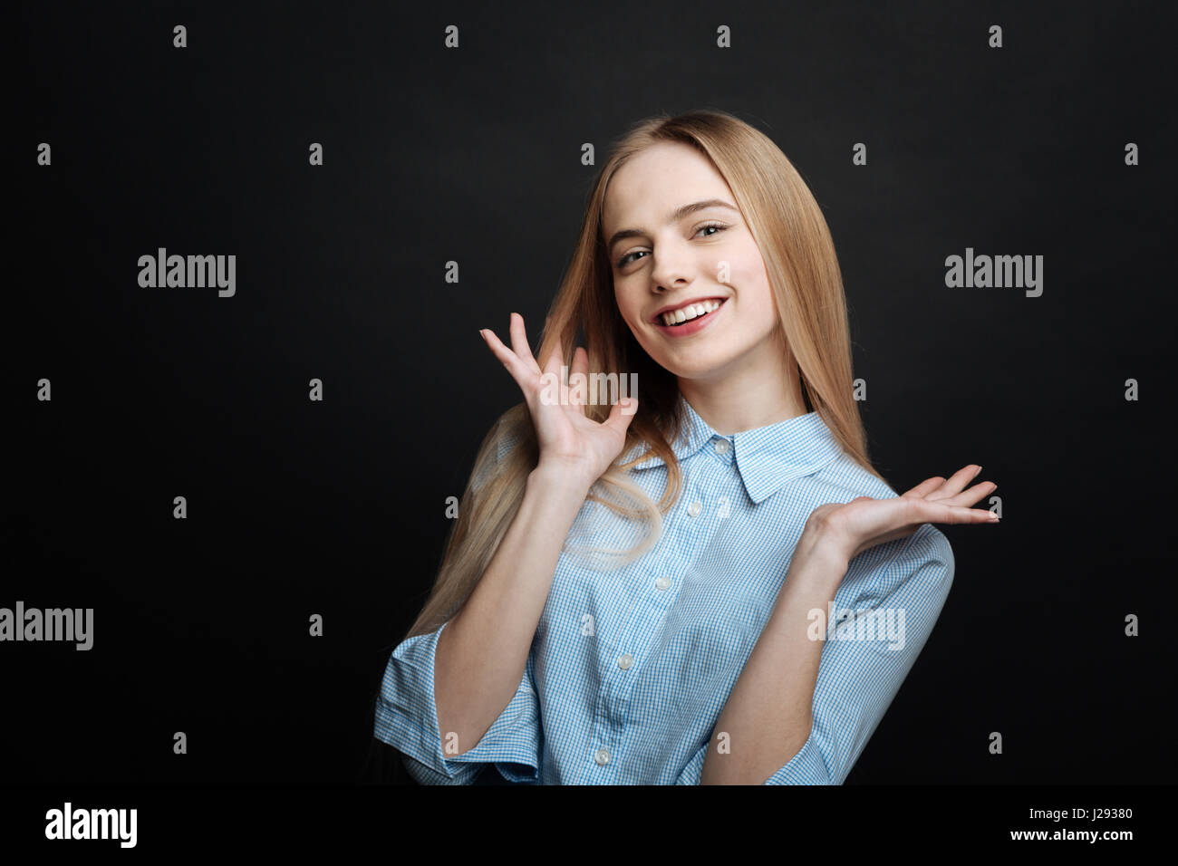 Cheerful teenager having fun in the black colored studio Stock Photo ...