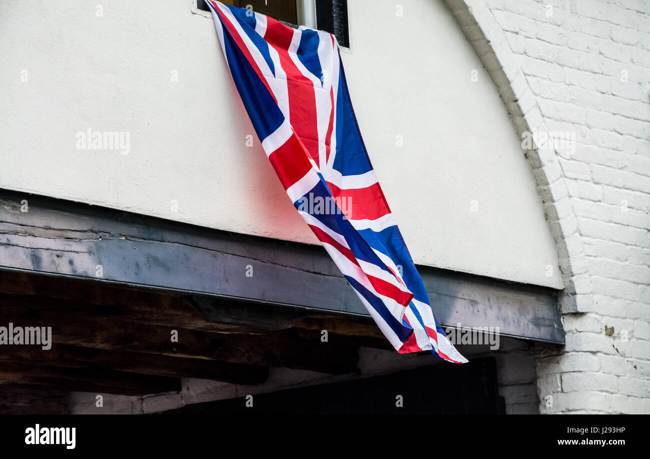 Union Jack draped out of a window, blowing in the wind. Great Britain ...
