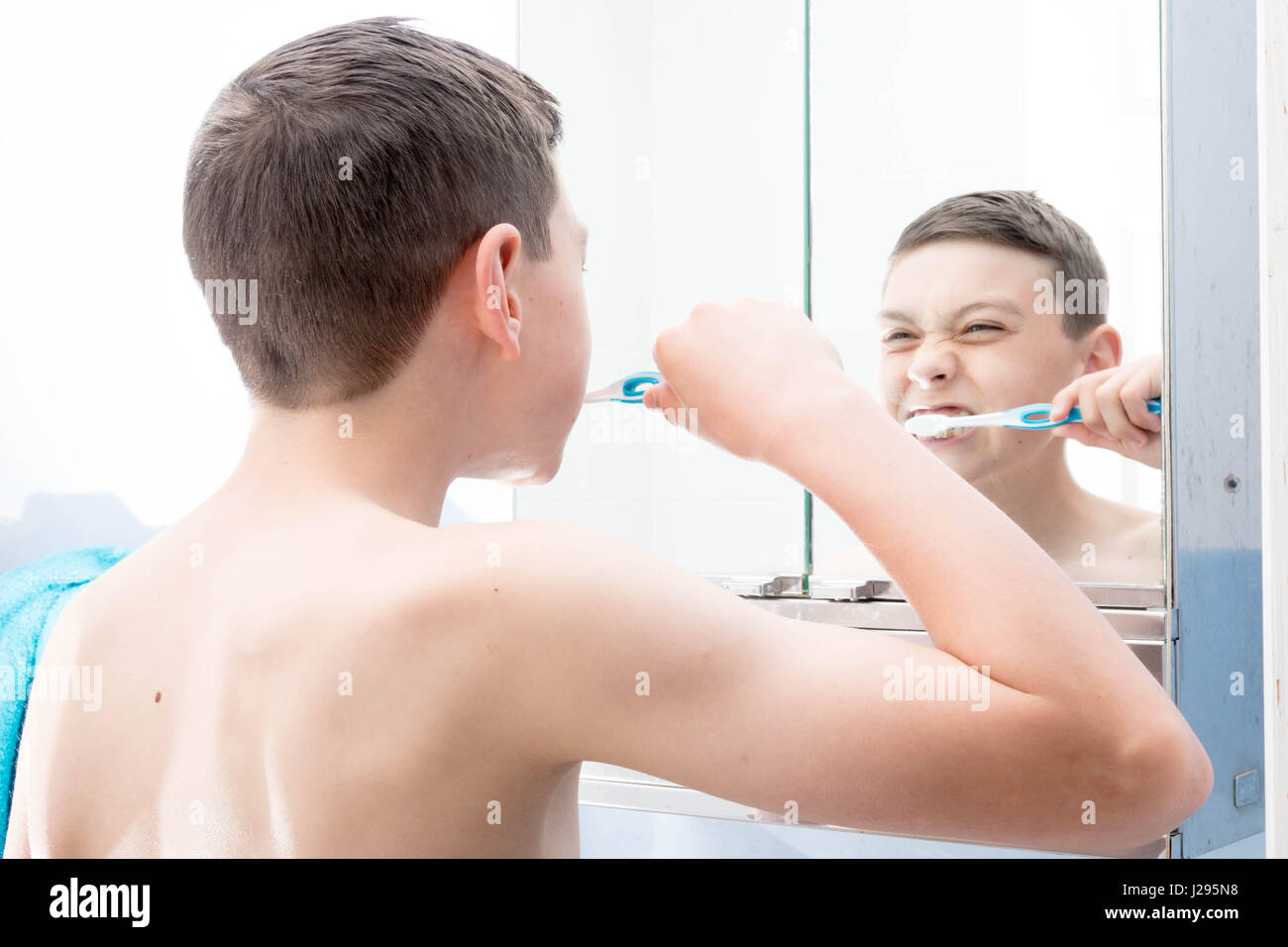 Young caucasian teenage boy brushing his teeth Stock Photo - Alamy