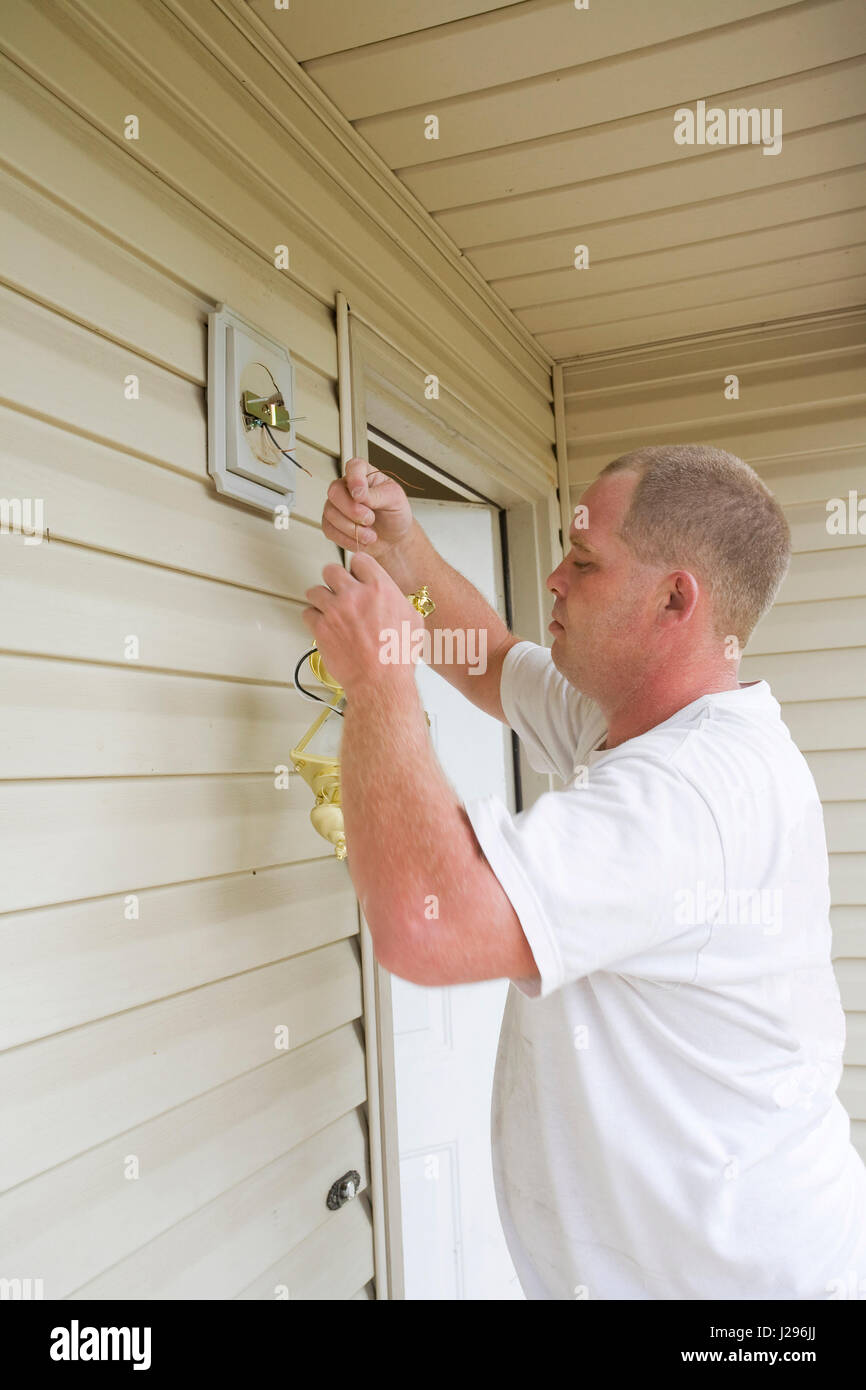 Construction worker installing light hi-res stock photography and ...