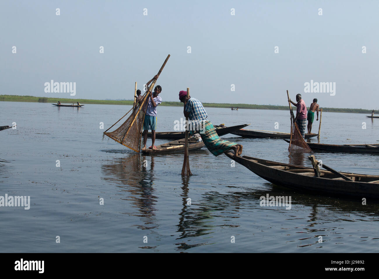 Fishermen fishing on the Tanguar Haor also called Tangua Haor using ...
