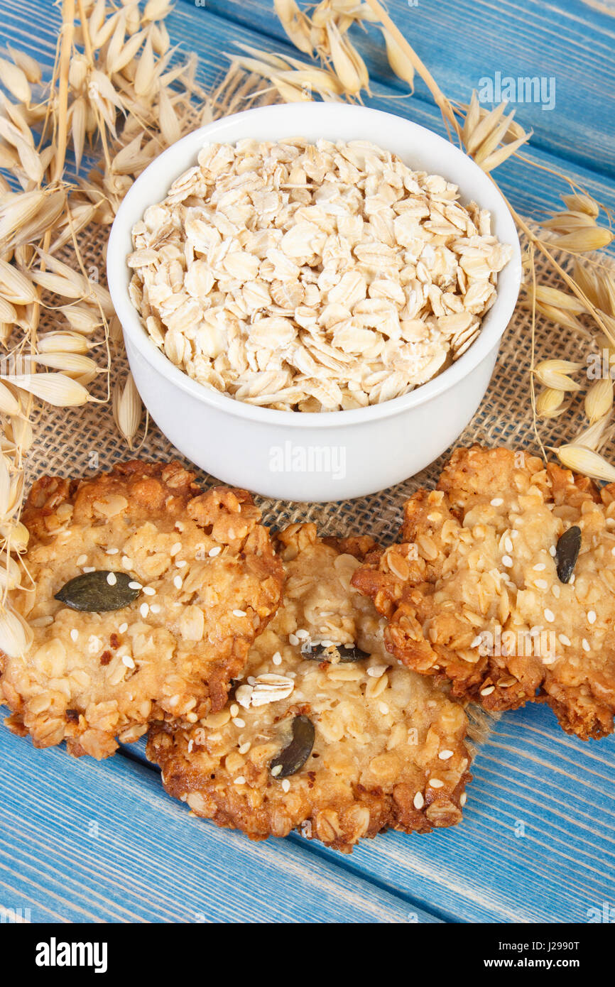 Fresh baked homemade crusty oatmeal cookies, flakes and ears of oat ...