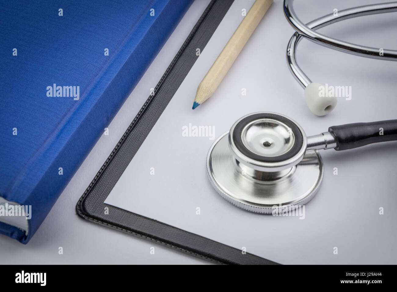 stethoscope and a book on white background Stock Photo - Alamy
