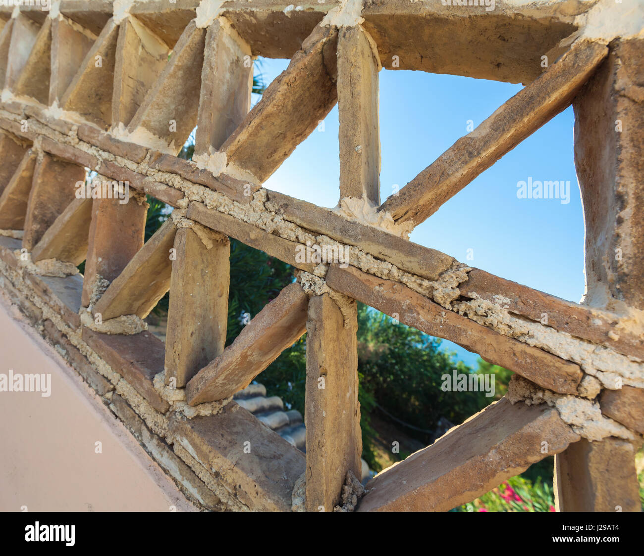 Old balcony railings made of clay blocks, Greek style architecture ...