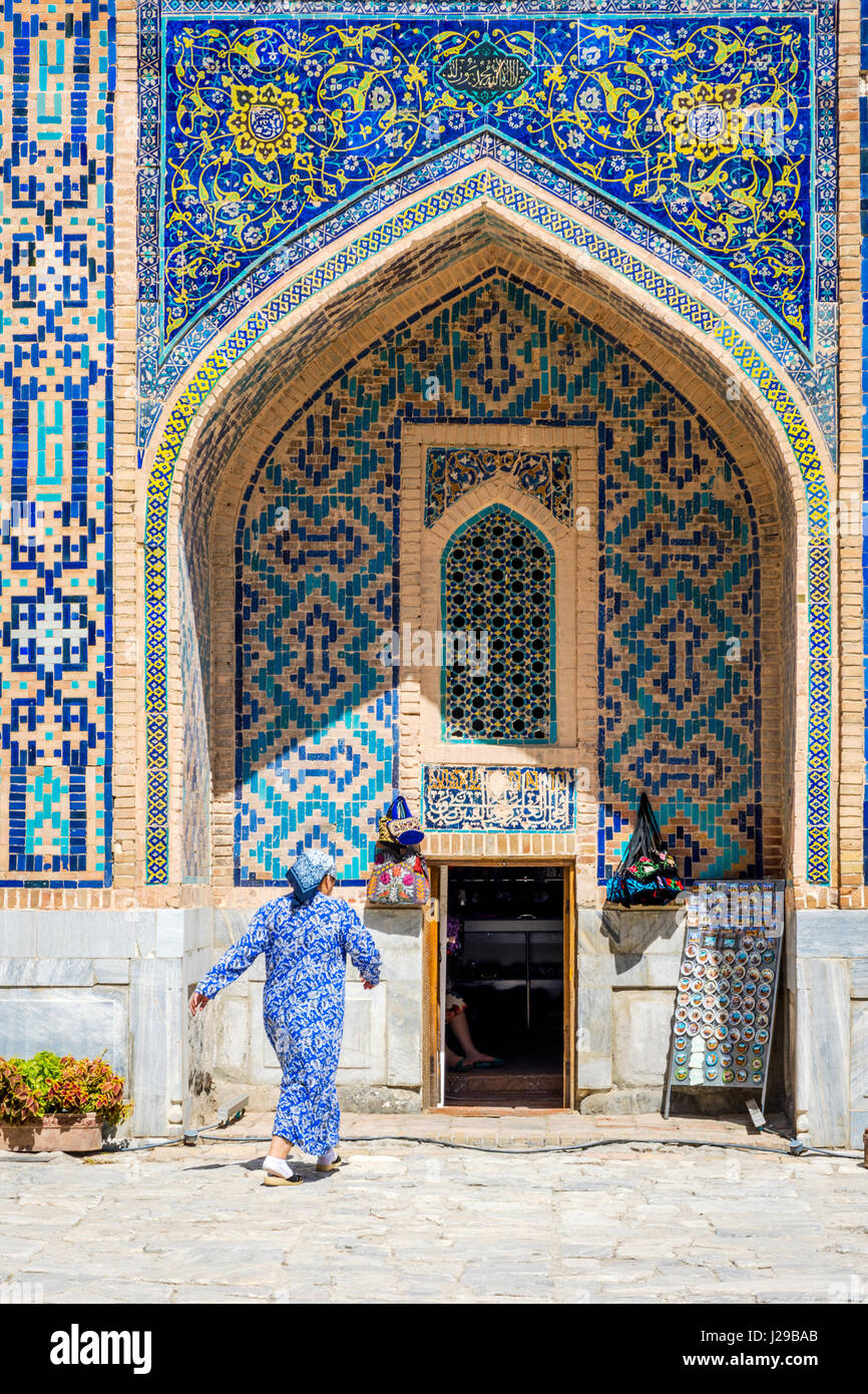 SAMARKAND, UZBEKISTAN - AUGUST 28: Woman passing the entrance to the ...