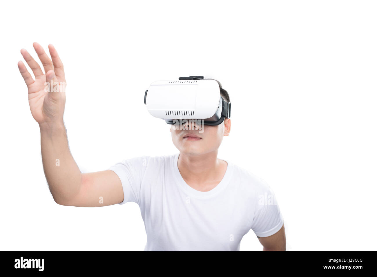 Happy young asian man using the virtual reality headset isolated on ...