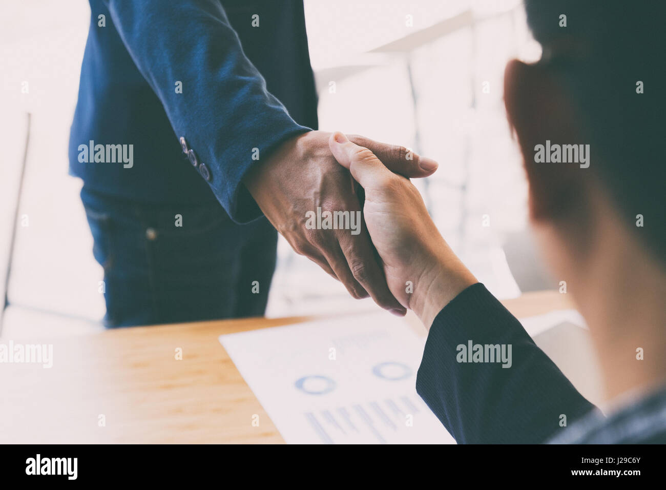 two businessman handshaking for successful deal after negotiation in ...