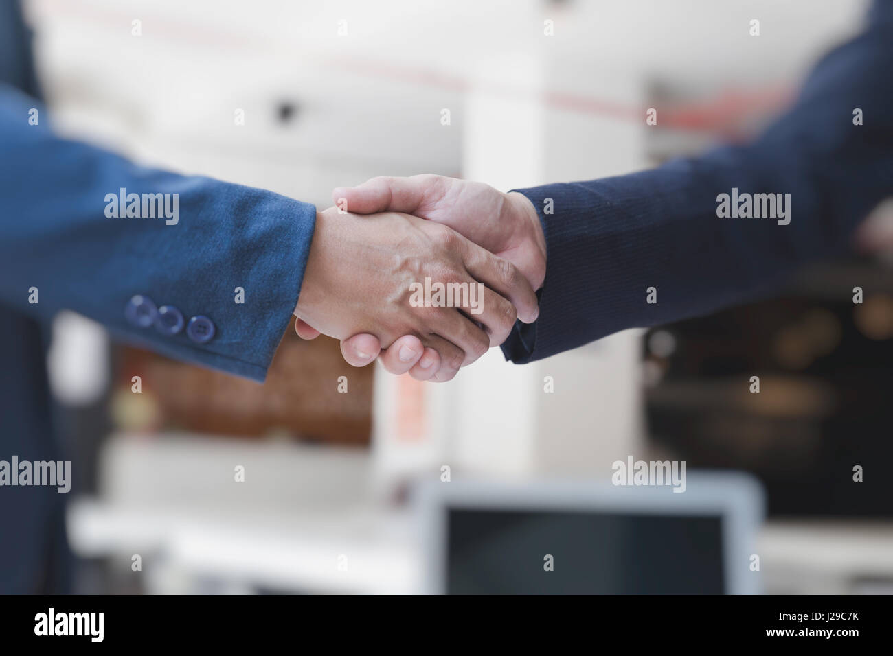two businessman handshaking for successful deal after negotiation in ...