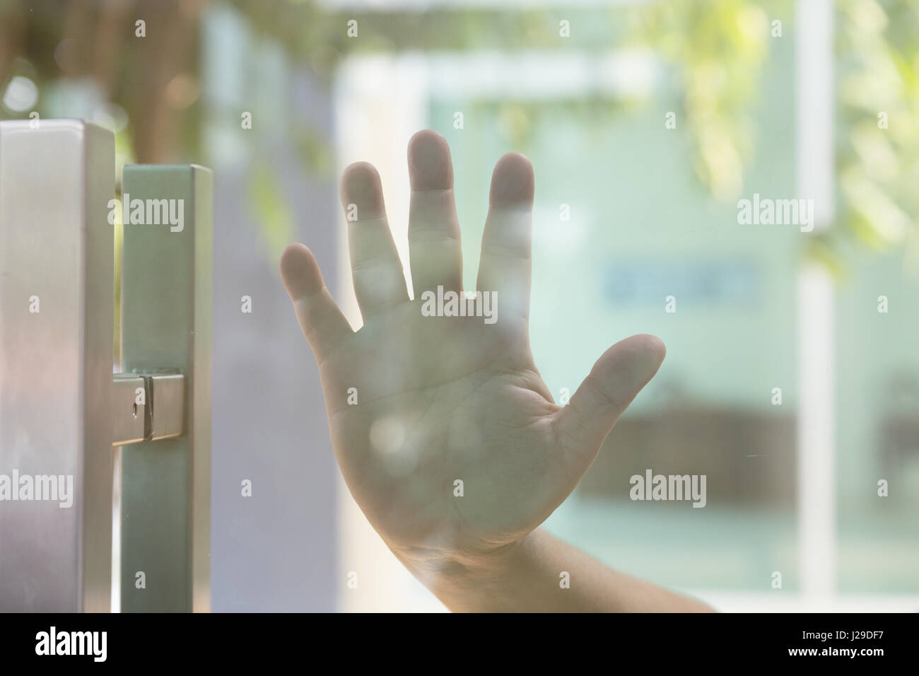 Man's hand pushing, opening glass door from outside Stock Photo - Alamy