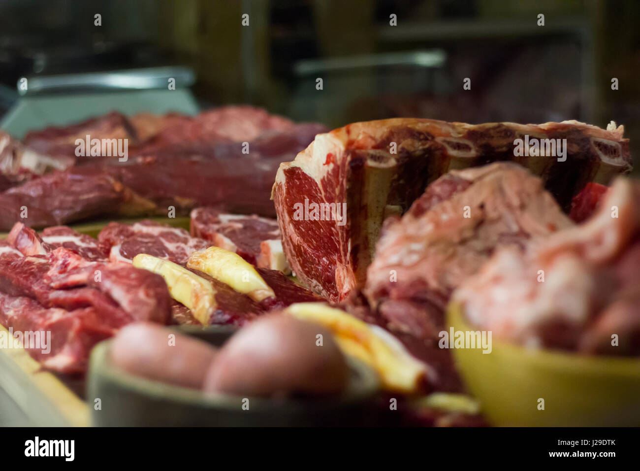 Different pieces of raw meat in a butcher window display Stock Photo ...