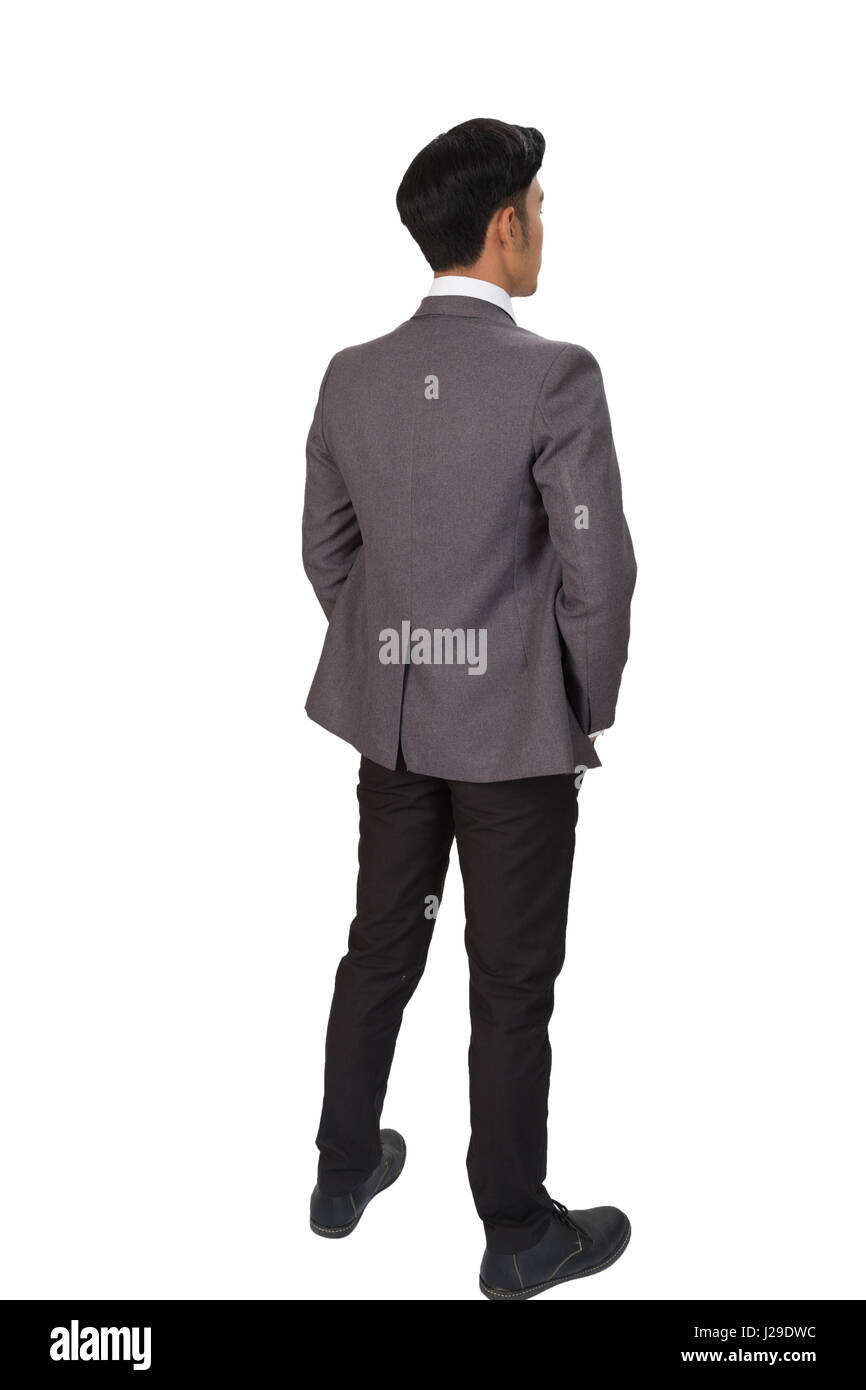 Full length of thoughtful businessman standing back to camera on white ...