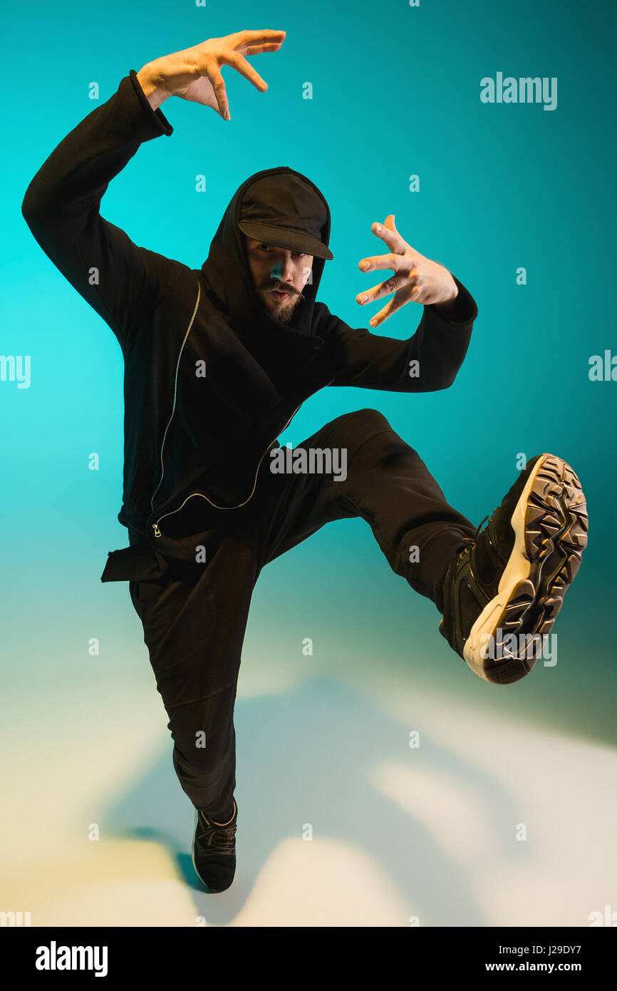 The silhouette of one hip hop male break dancer dancing on colorful ...