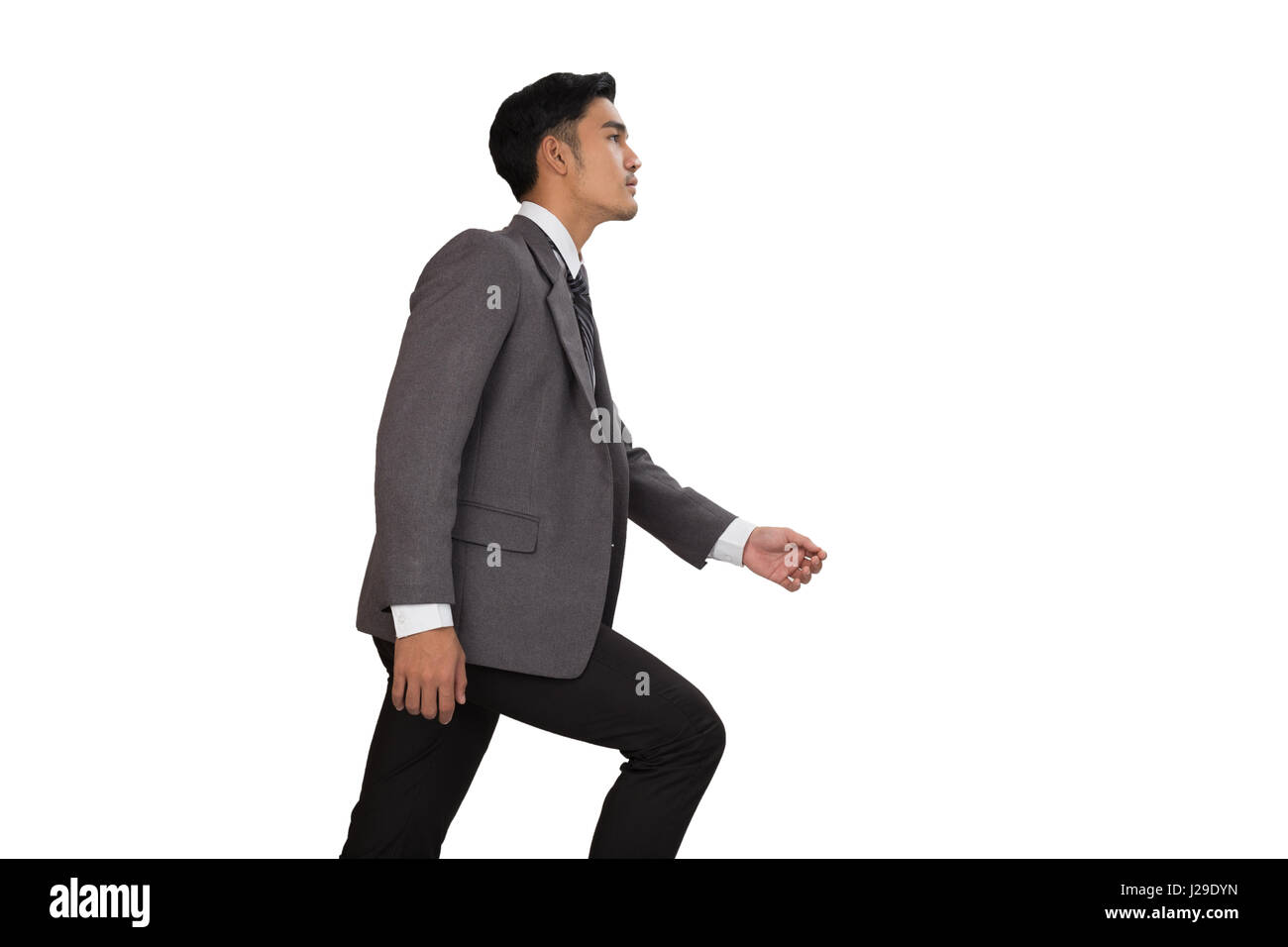 Side view of a man stepping up a staircase. Confident businessman ...