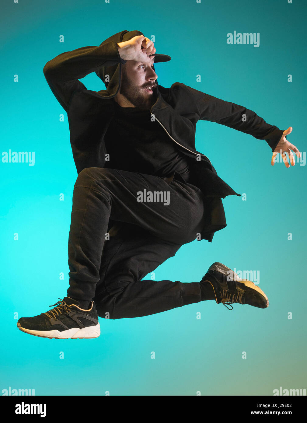 The silhouette of one hip hop male break dancer dancing on colorful ...