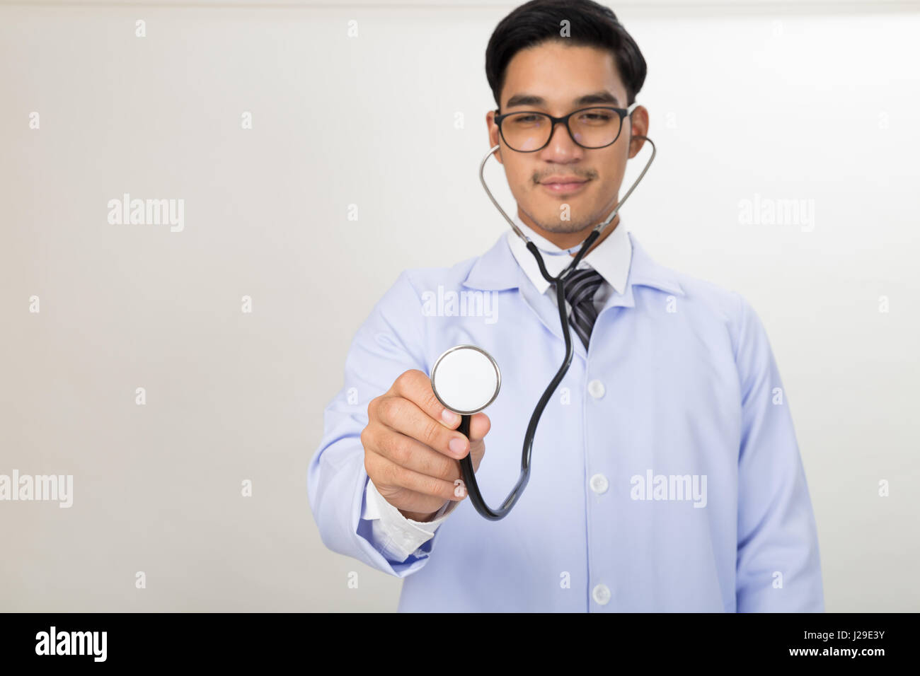Doctor, physician with a stethoscope in the hands at workplace - health ...