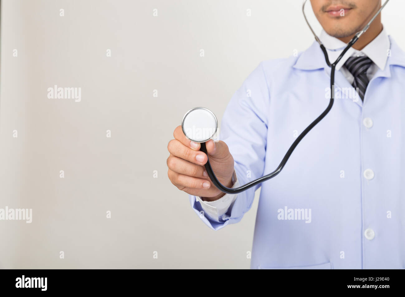 Doctor, physician with a stethoscope in the hands at workplace - health ...