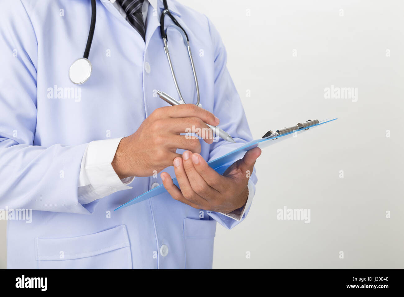 doctor hand holding pen writing something on clipboard. Medical care ...