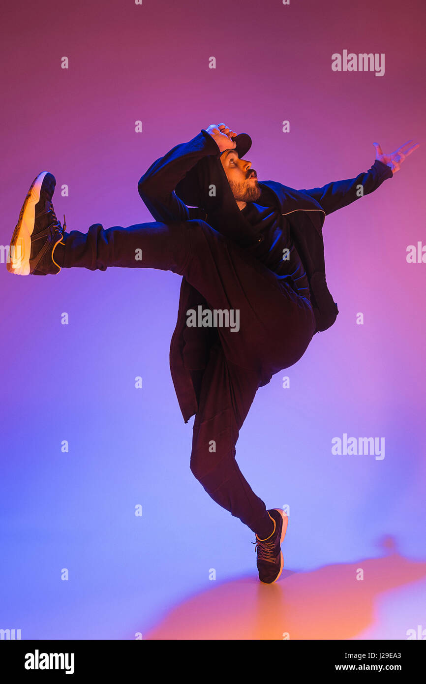 The silhouette of one hip hop male break dancer dancing on colorful ...