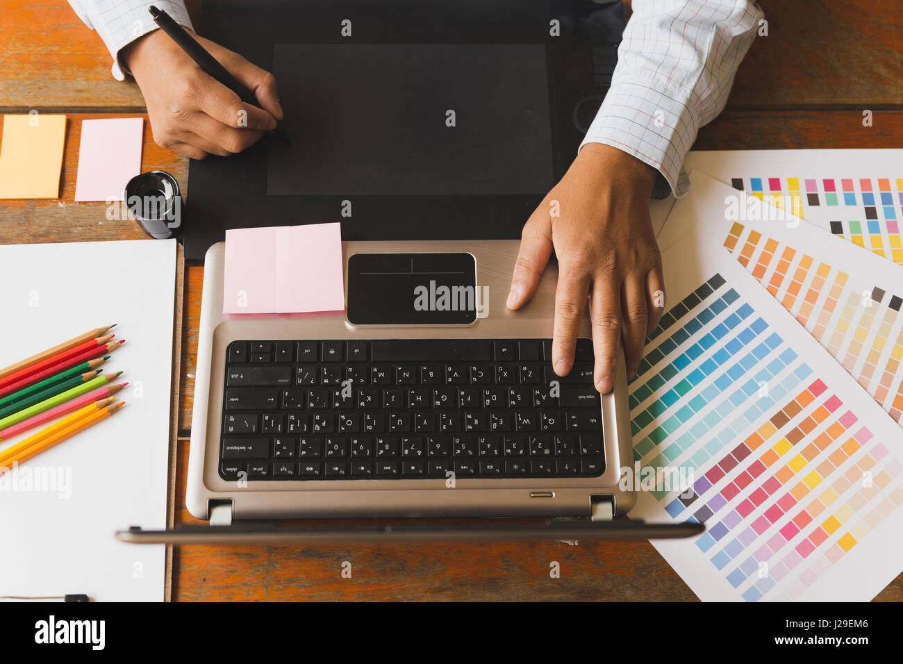 freelance artist graphic designer using digital tablet, computer ...