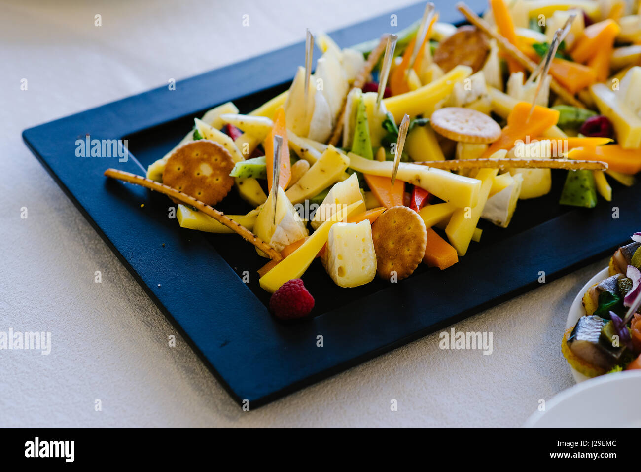 The concept of healthy food, fruit cheese and crackers on the plate in ...