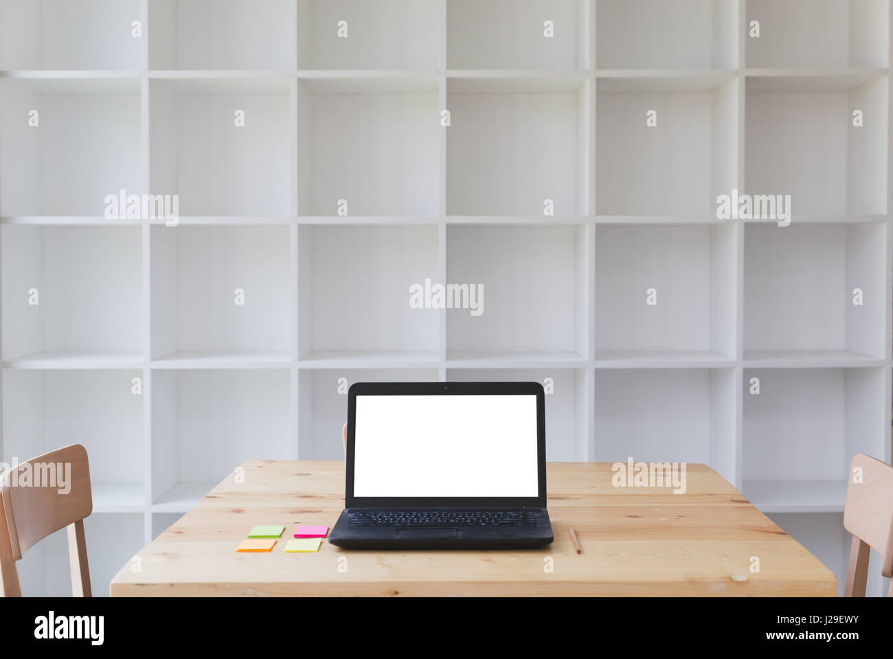 Working at desk with sticky note, pencil and laptop computer at office ...