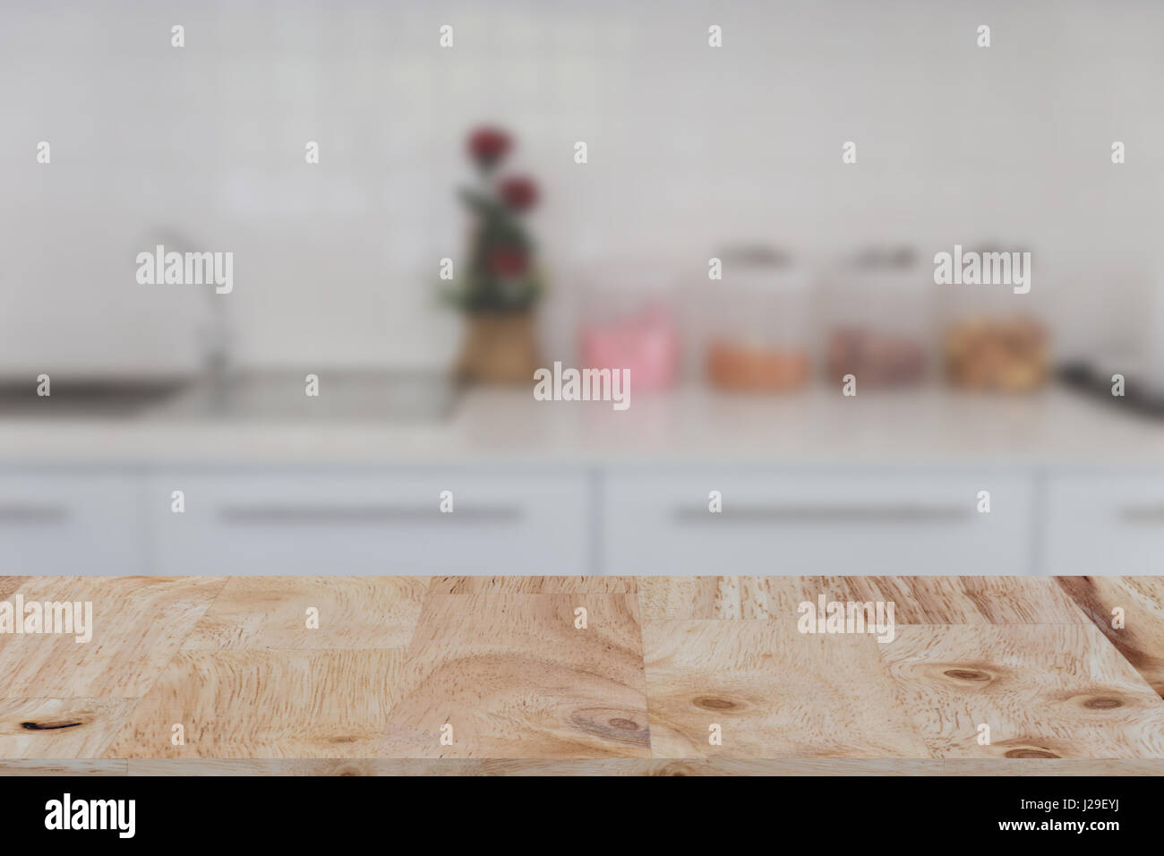defocused modern white kitchen background with selected focus wood ...